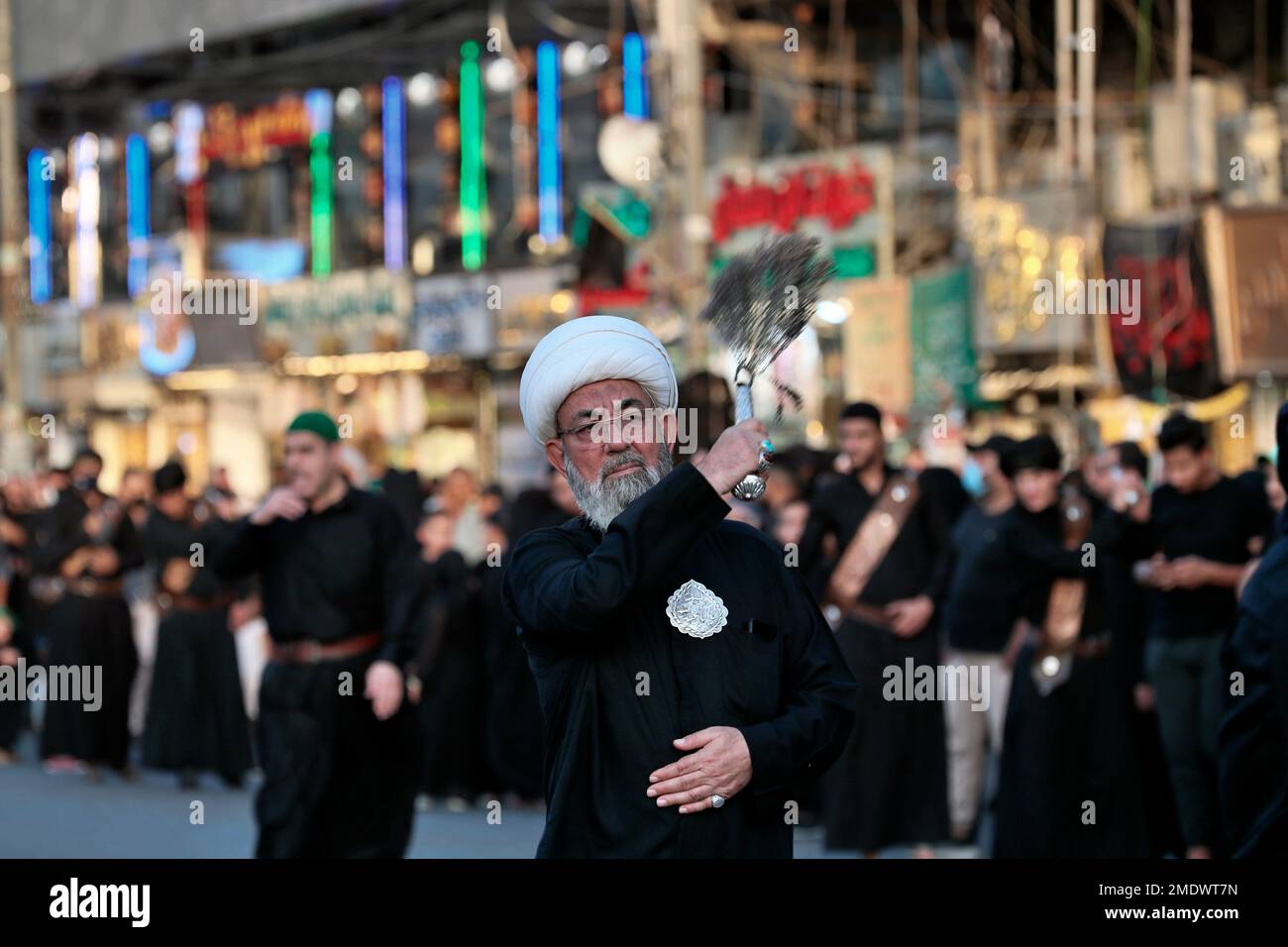 A Shiite faithful pilgrim beats himself with chains as a sign of grief ...