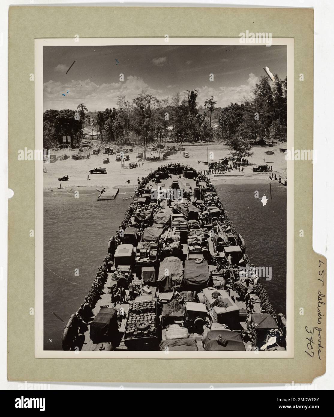 A Coast Guard-manned LST (Landing Ship Tank) unloads supplies on a ...