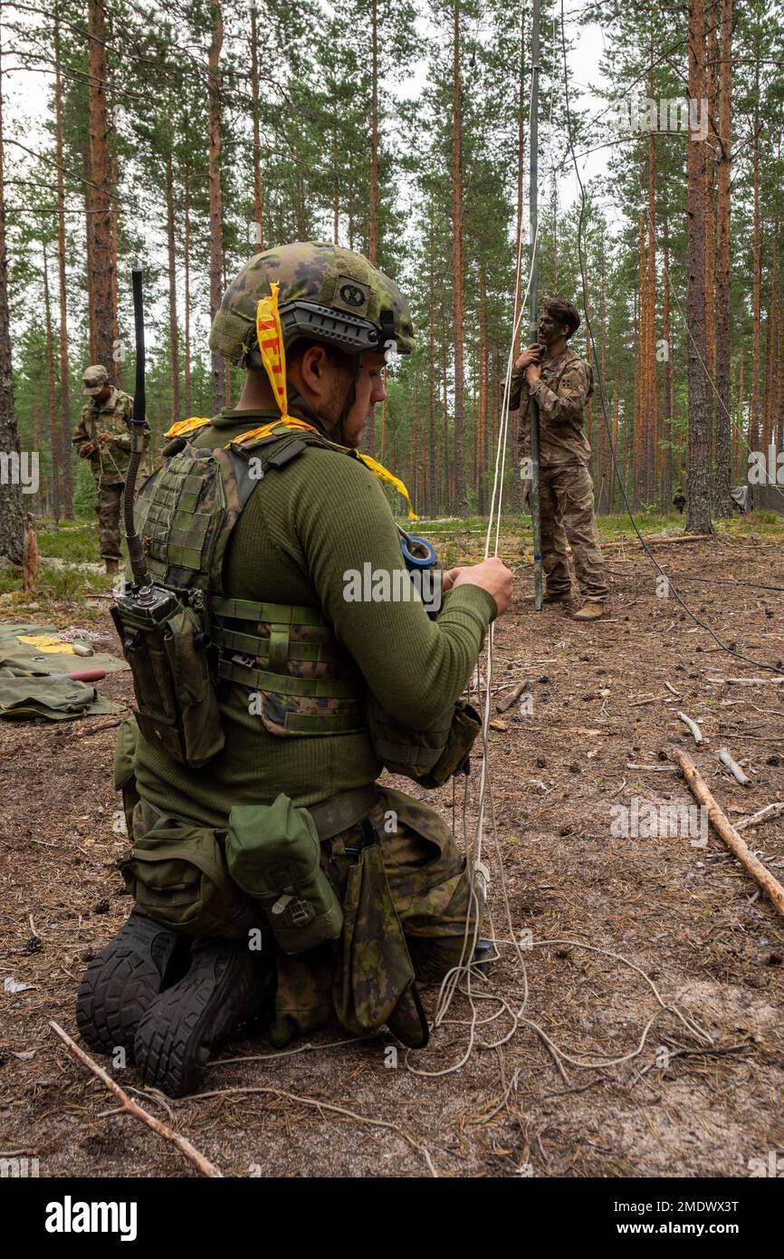 From left, U.S. Army Capt. Paris Scroggins, a field artillery officer ...