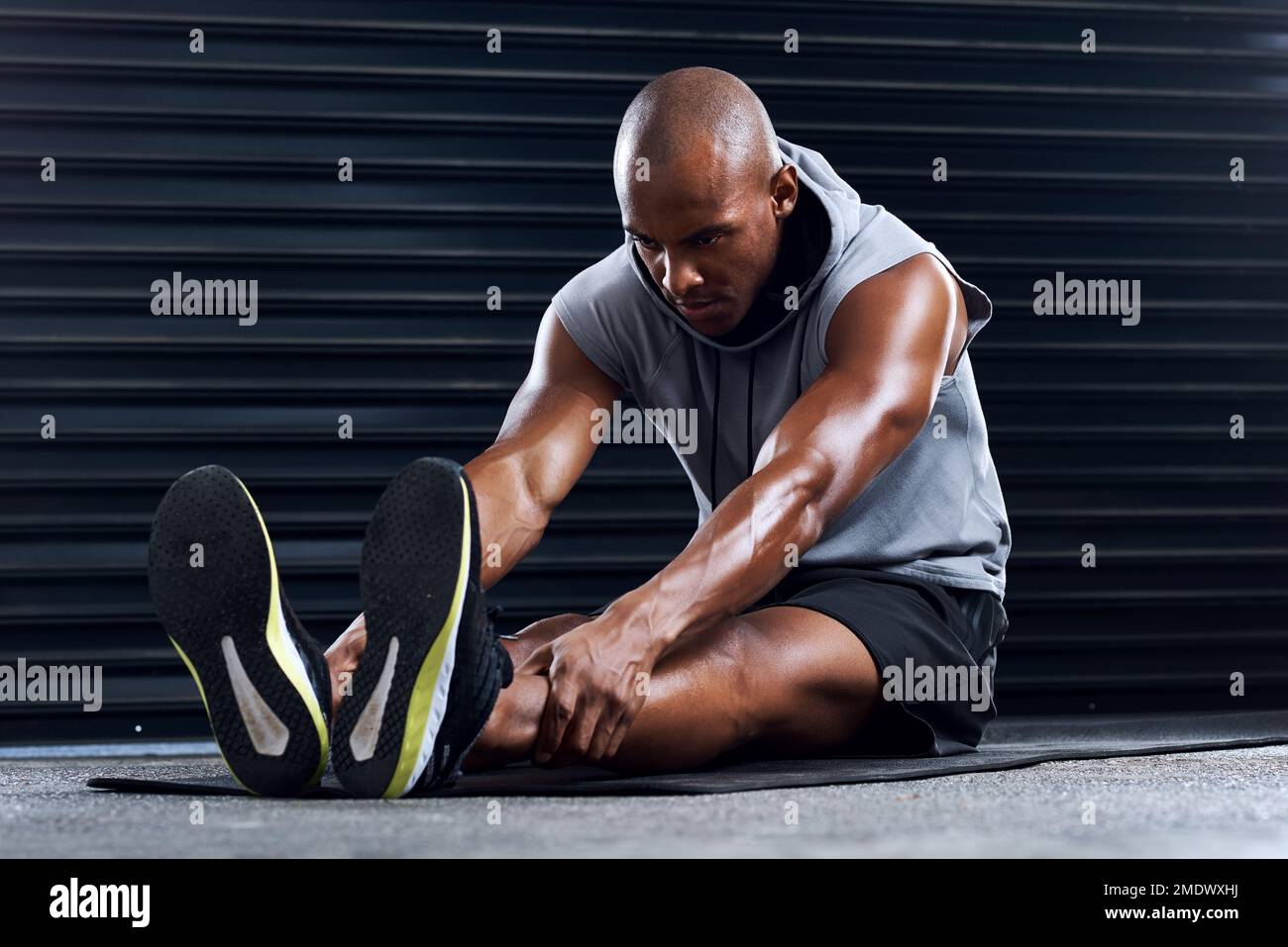 It feels good to take care of yourself. a sporty young man stretching ...