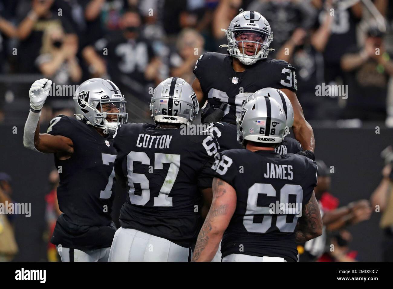 Las Vegas Raiders running back Trey Ragas, top right, celebrates after ...