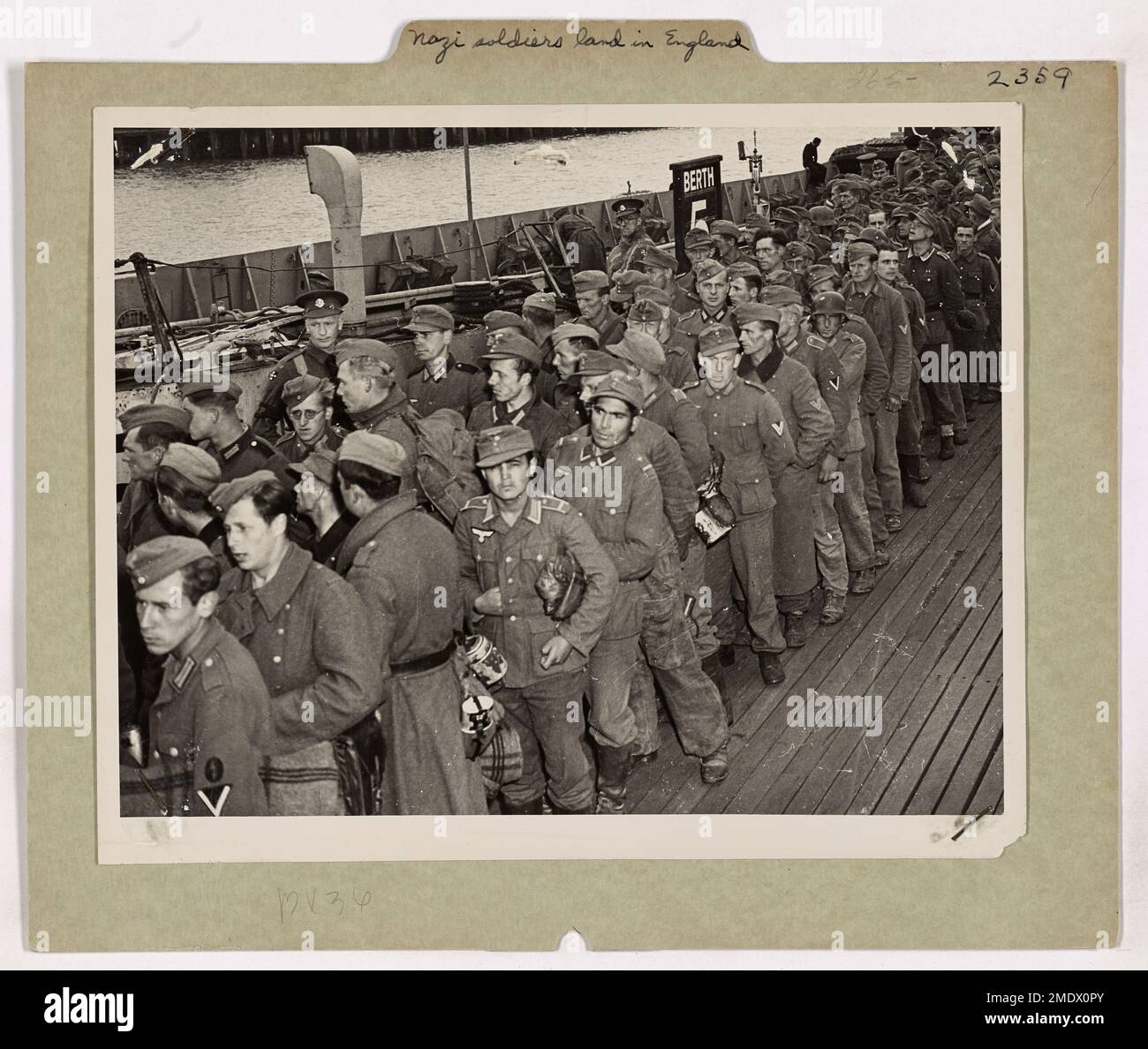 Captured Nazi soldiers are marched from a British landing craft at a ...