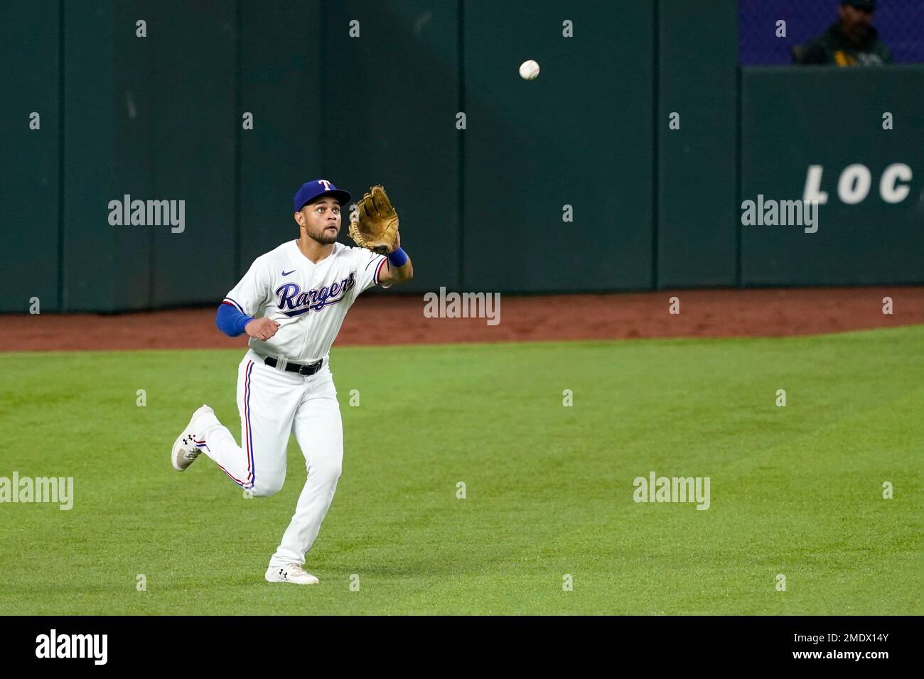 Texas Rangers left fielder Jason Martin reaches up to catch a flyout by ...