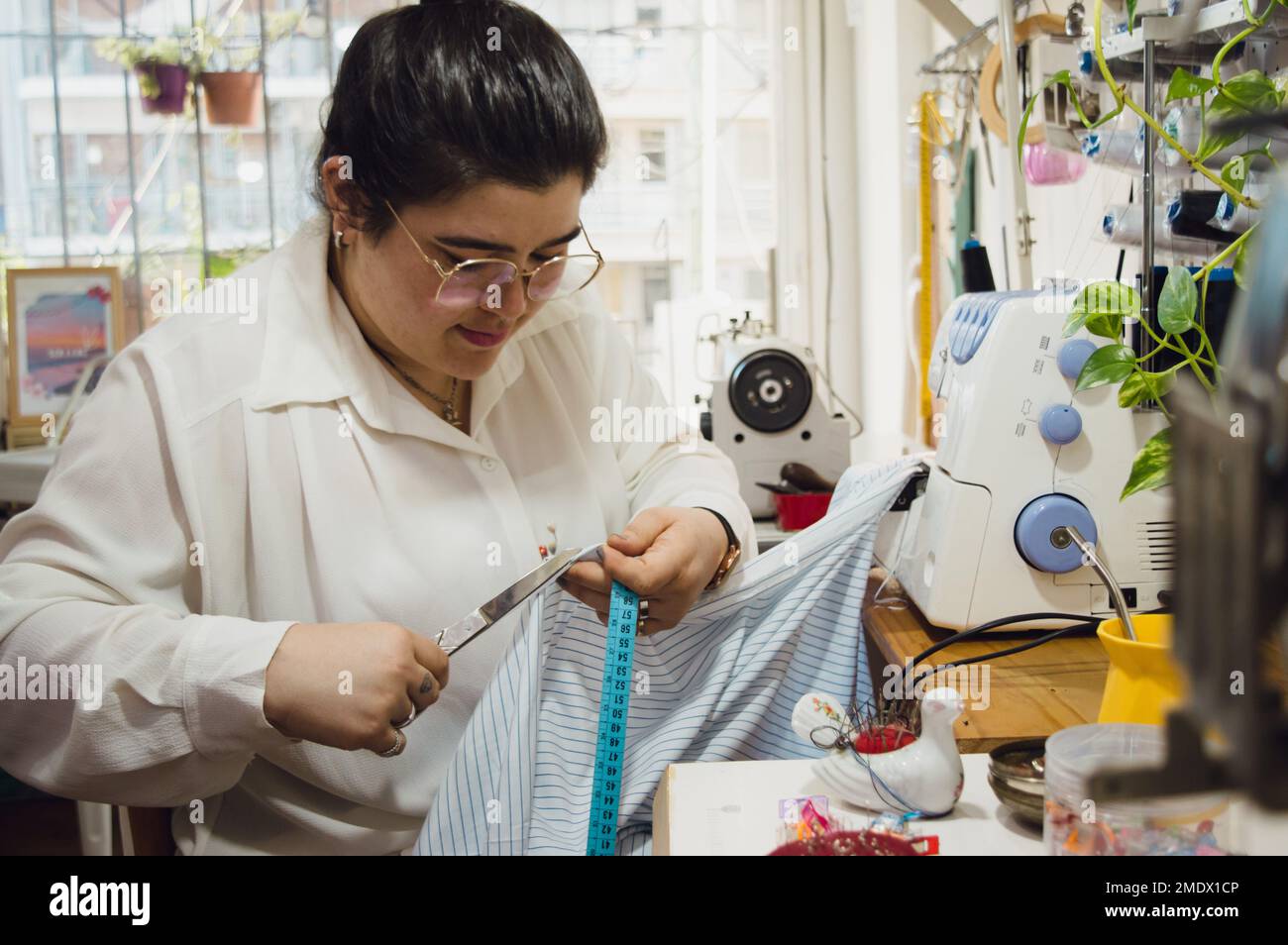 Argentinian latin young woman with glasses, standing working in her ...