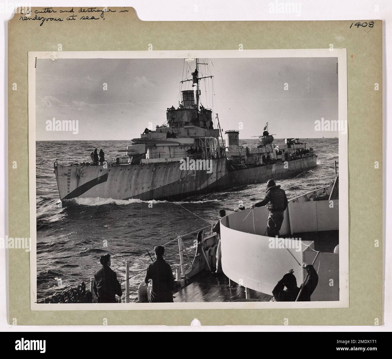This image shows a Coast Guard cutter and a destroyer meeting at sea ...