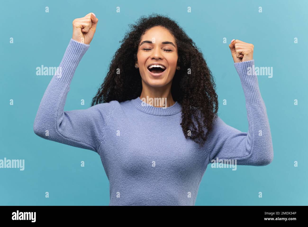 Portrait of excited overjoyed fashionably dressed woman standing with ...