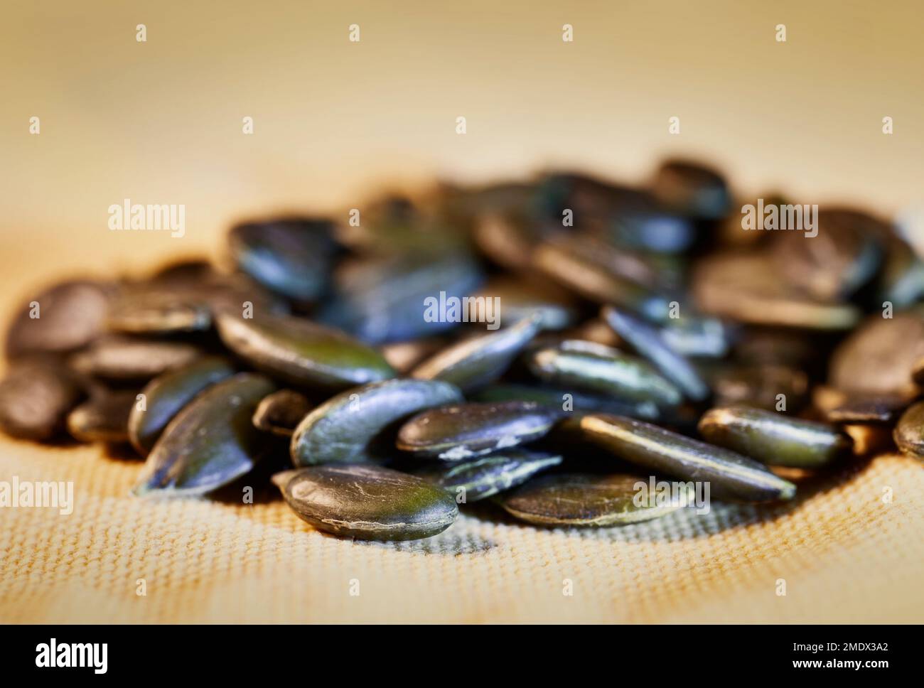 Pumpkin seeds on yellow cloth , healthy eating Stock Photo - Alamy