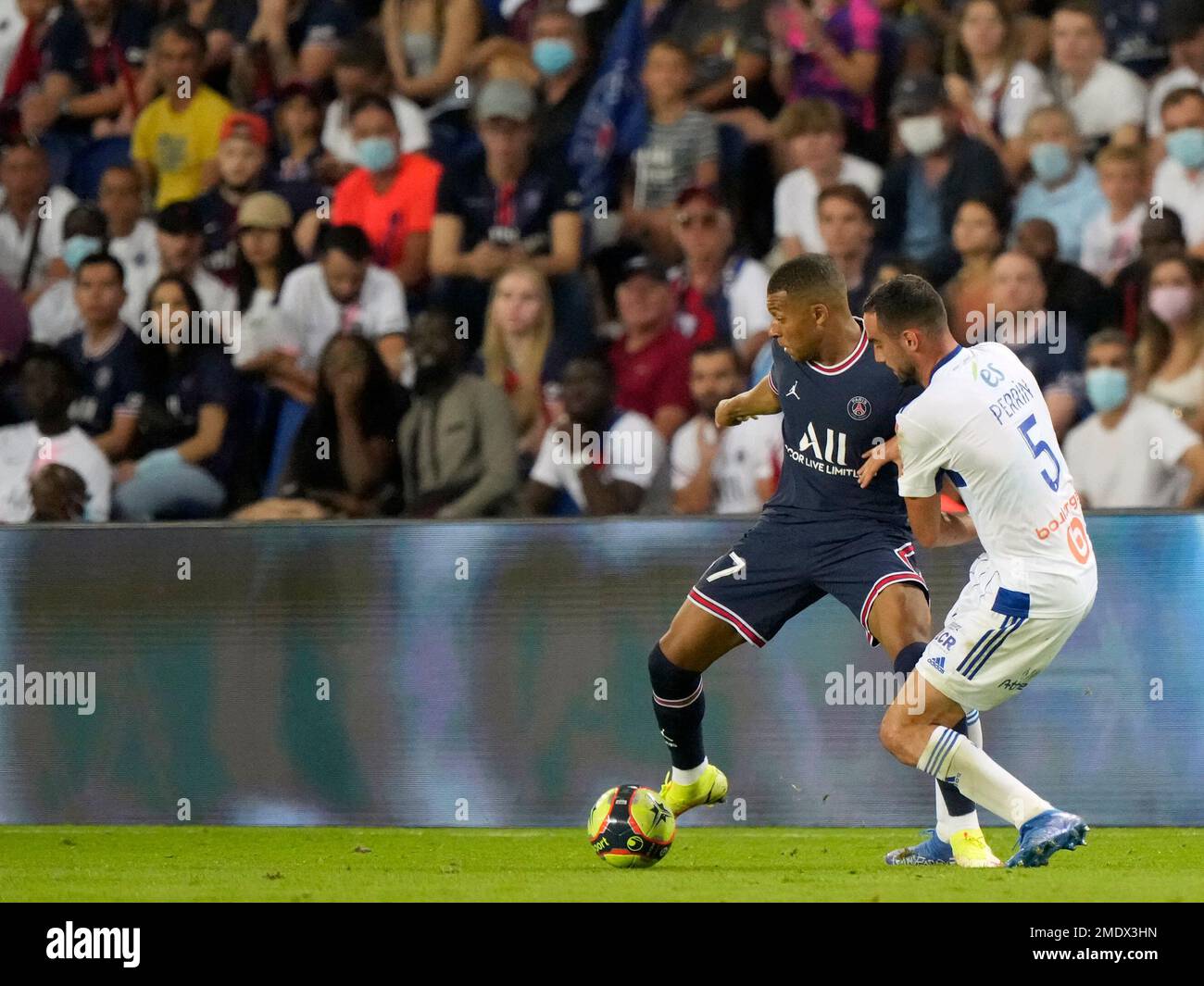 PSG's Kylian Mbappe, left, duels for the ball with Strasbourg's Lucas ...