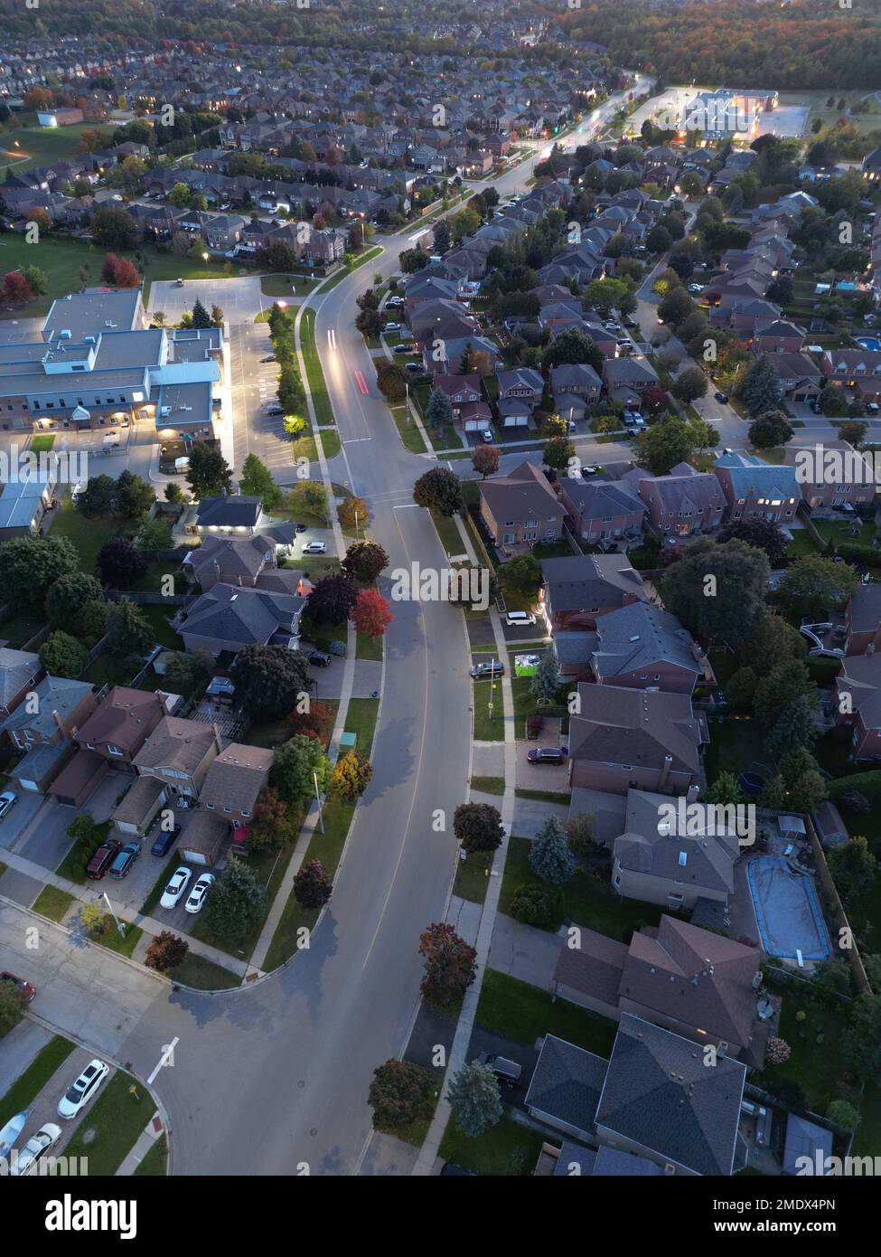 An aerial shot of a small calm town with identical houses and empty ...