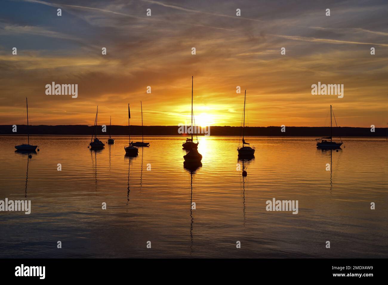 Sailboats at sunset in Herrsching Bay on Lake Ammer, Bavaria, Germany ...