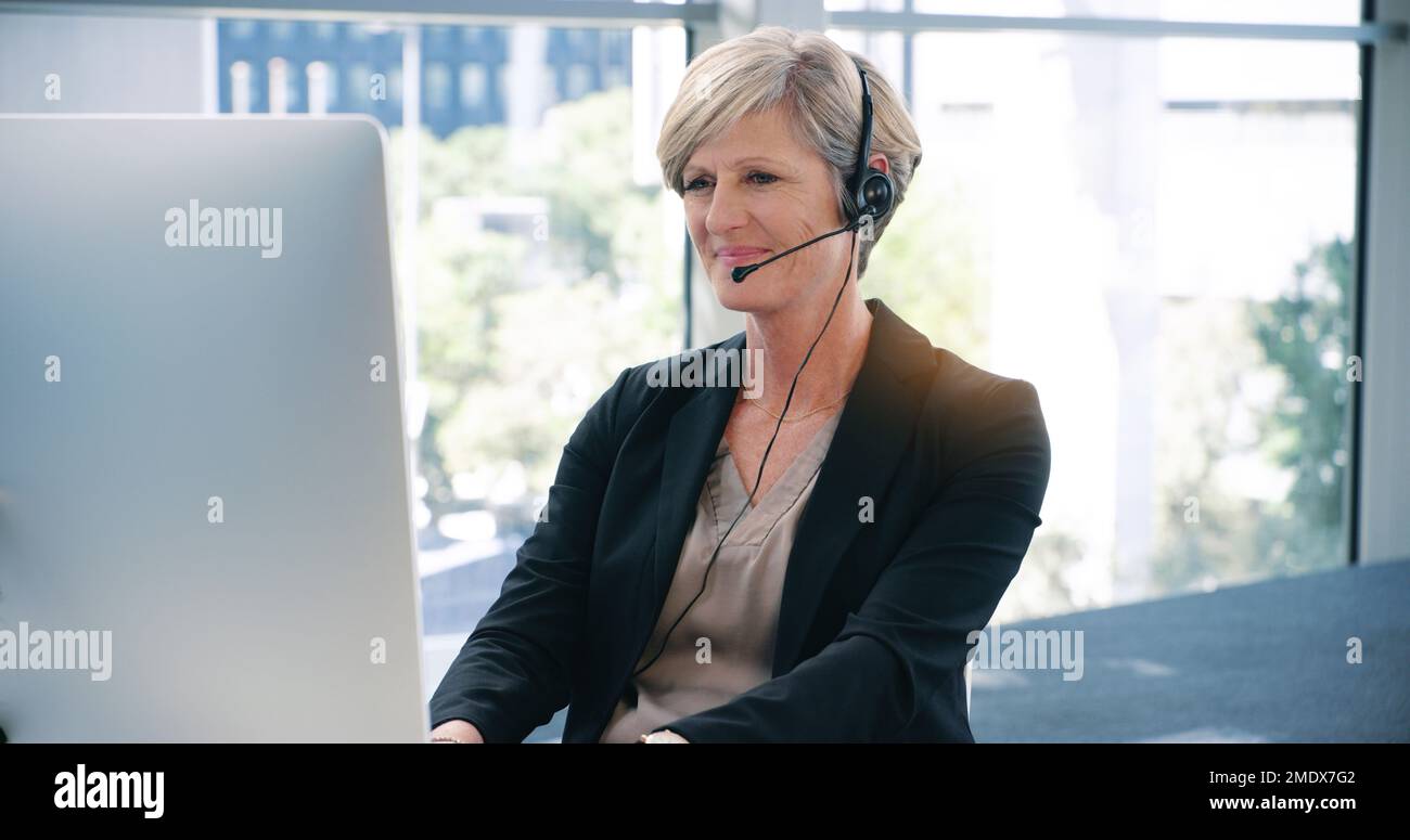 She handles every call with ease. a mature businesswoman wearing ...