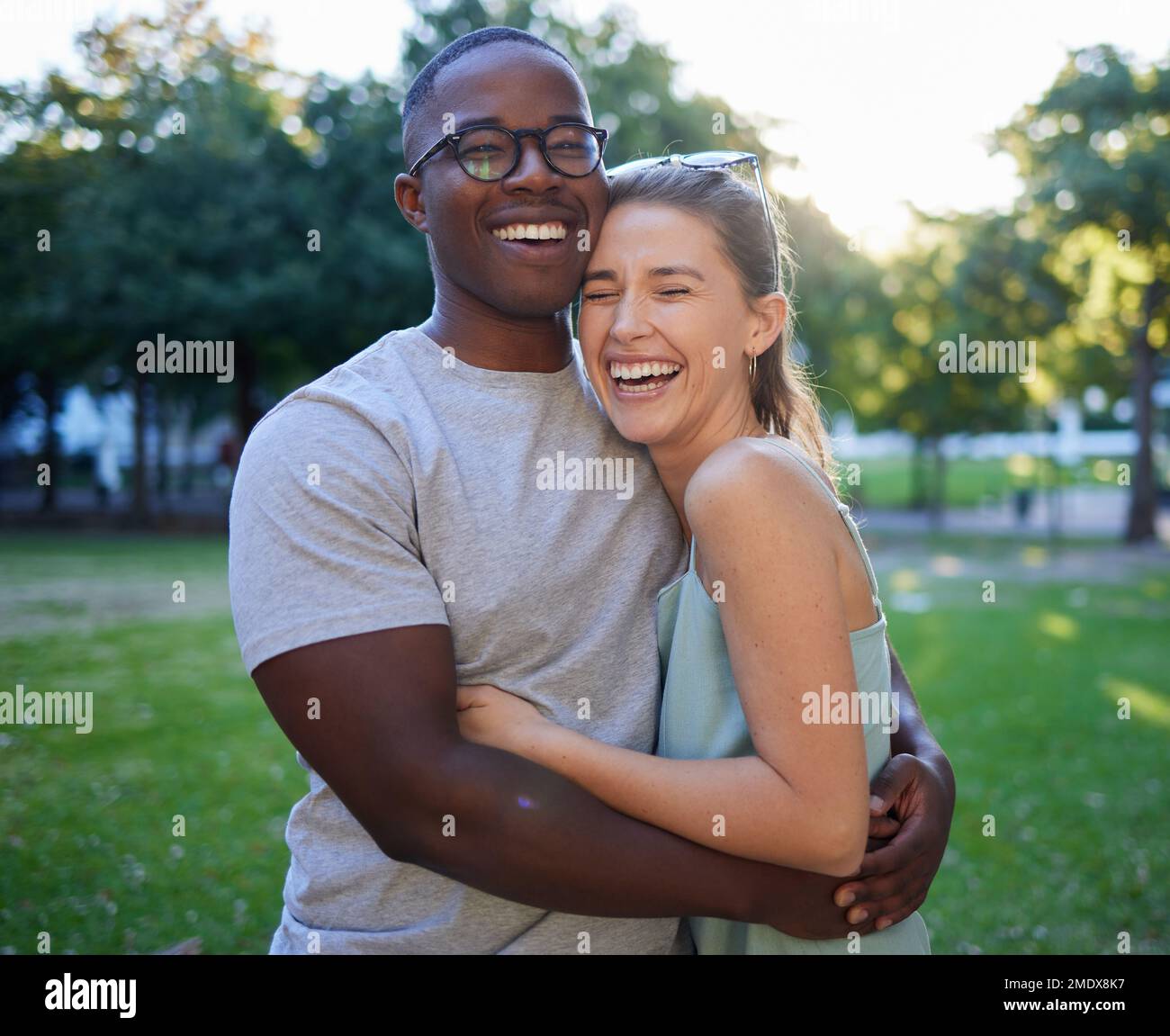 Love Interracial Or Couple Of Friends Hug In A Park On A Happy