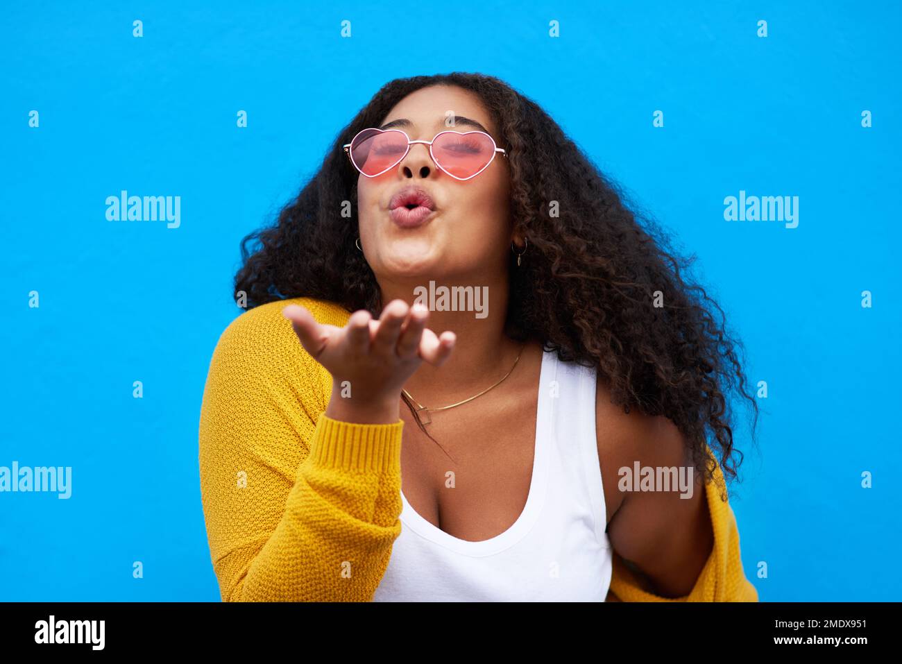 Here, catch my kisses. Studio portrait of an attractive young woman ...