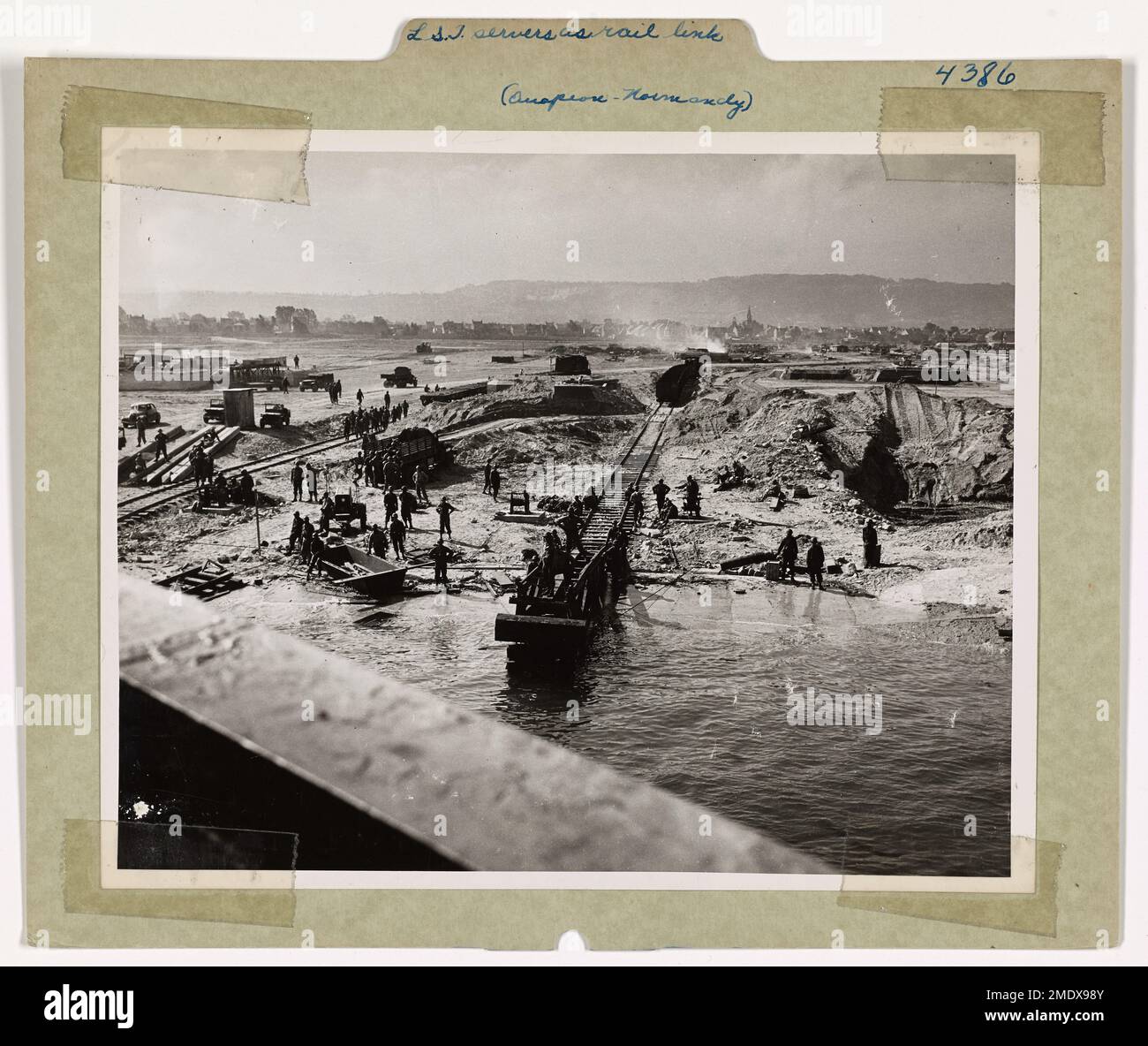 Coast Guard-manned LST Serves as Floating Rail Link. A rail bridge ...