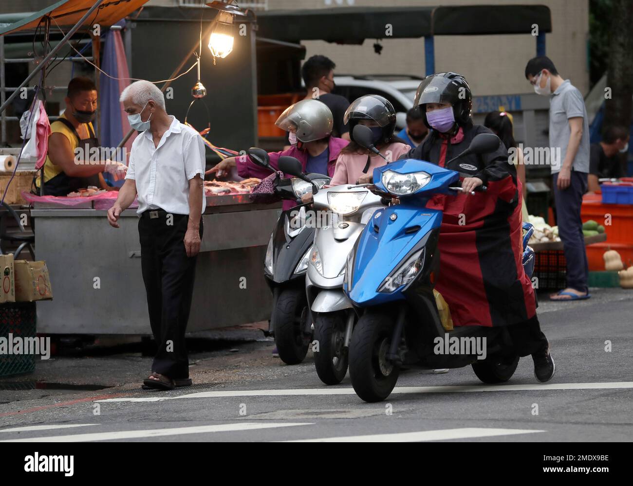 People wear face masks to protect against the spread of the coronavirus ...
