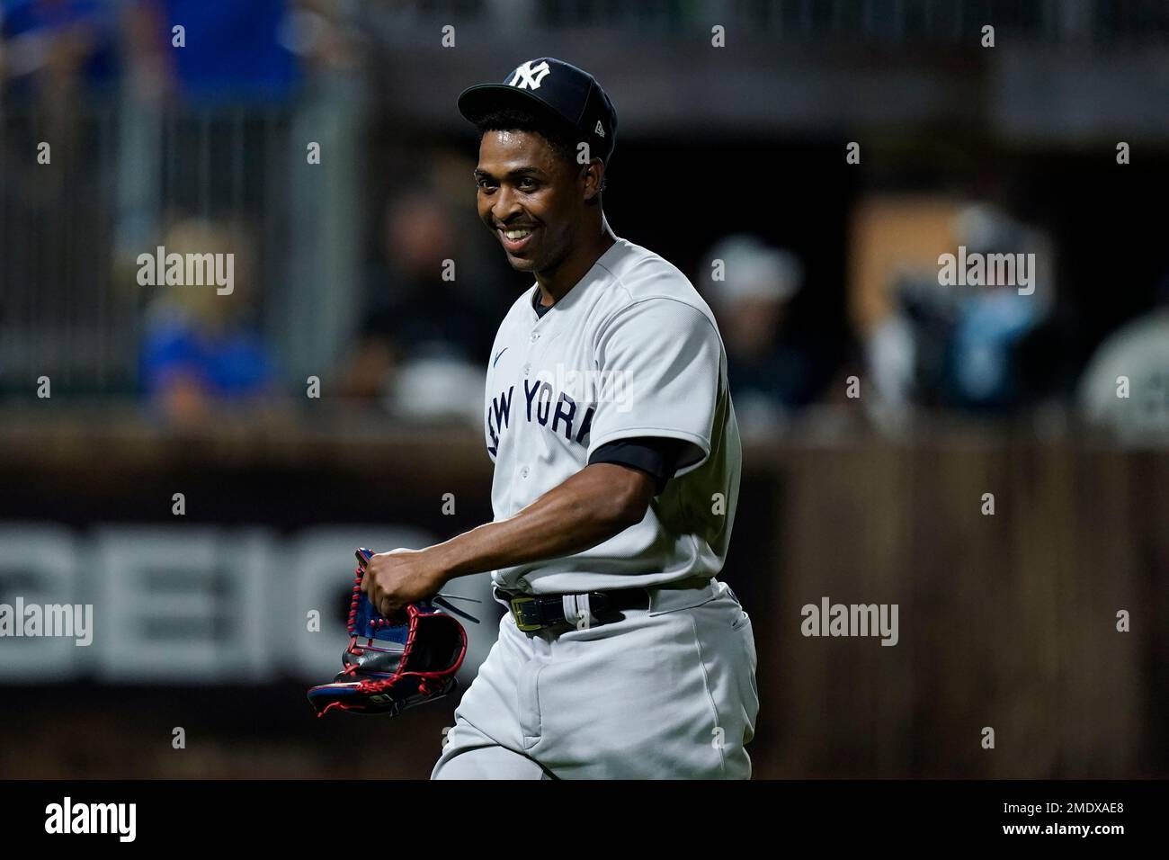 New York Yankees relief pitcher Joely Rodriguez smiles as he walks to ...