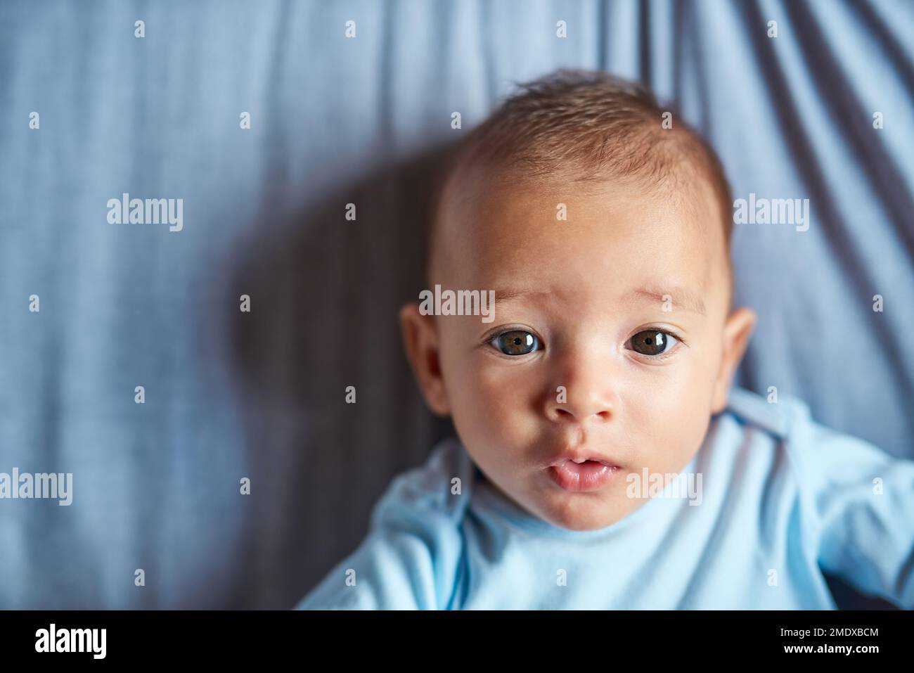 The sweetest face in the world. Portrait of an adorable baby boy laying ...