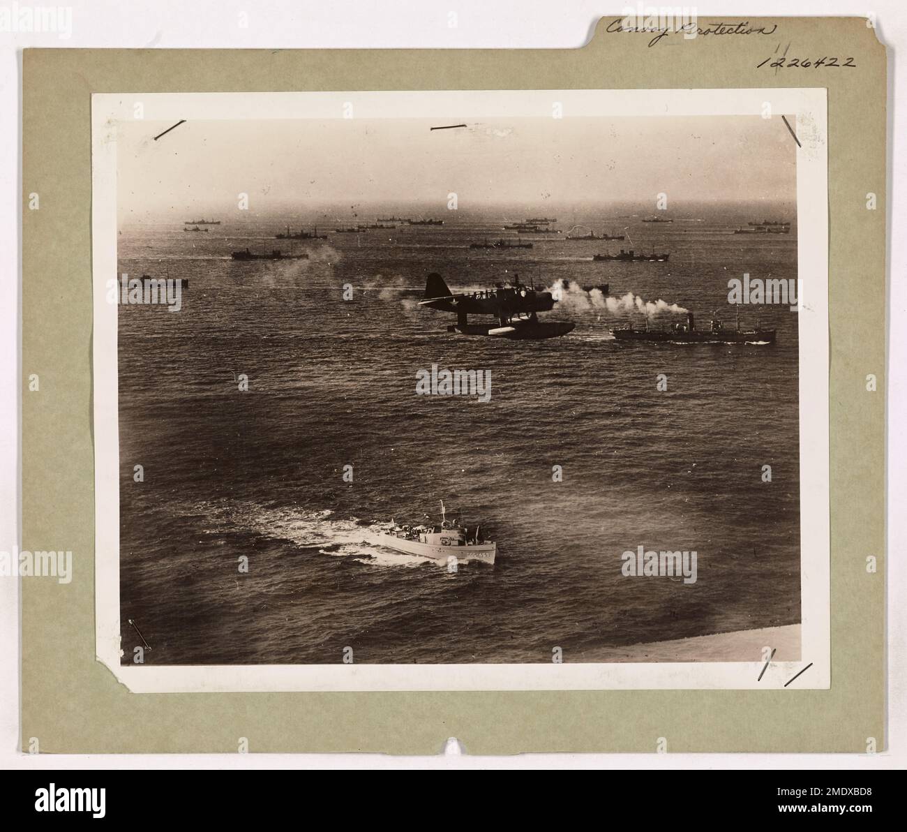 This image shows the U.S. Coast Guard providing protection to a convoy ...