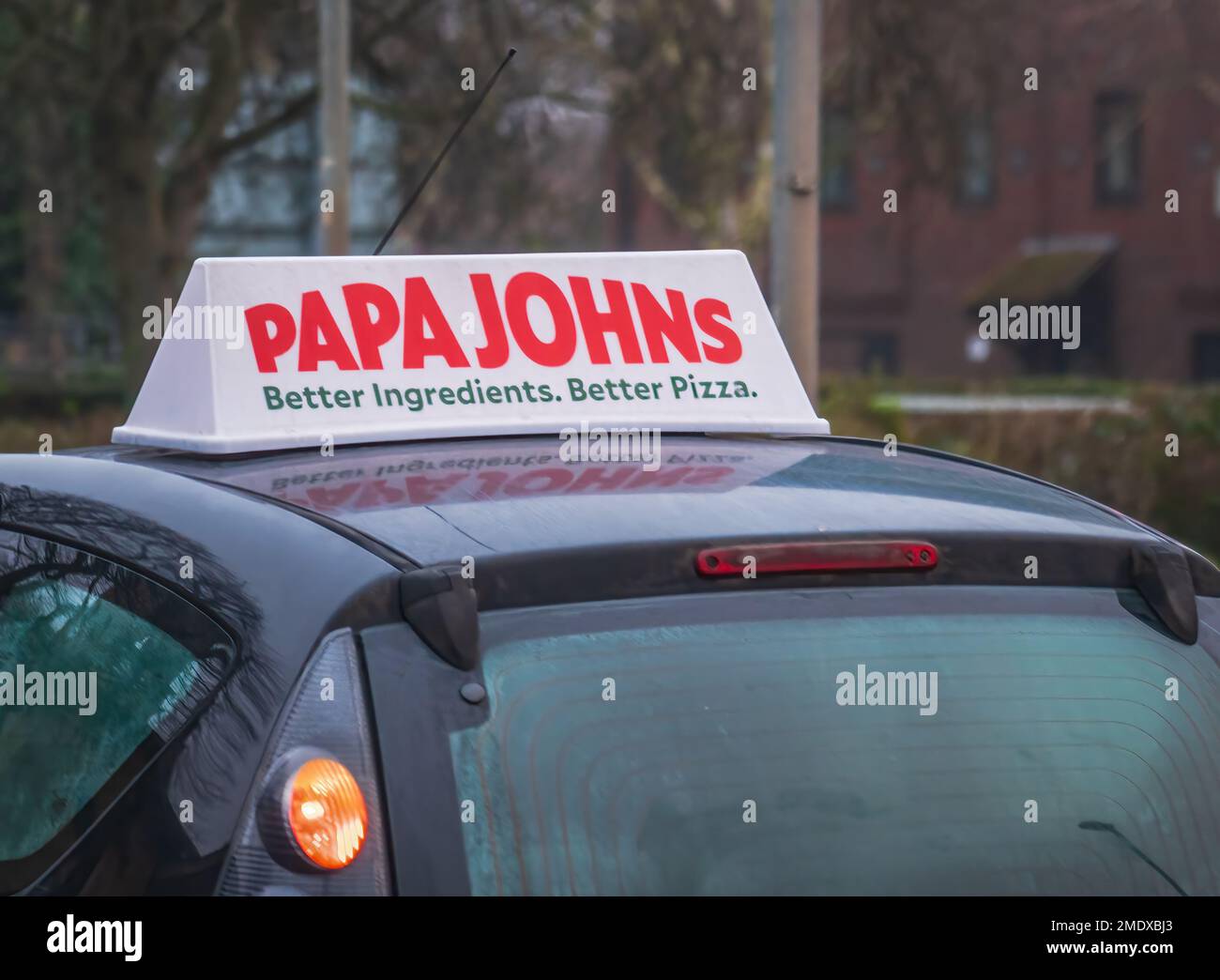 papa johns pizza sign over a car in Bristol England Stock Photo - Alamy