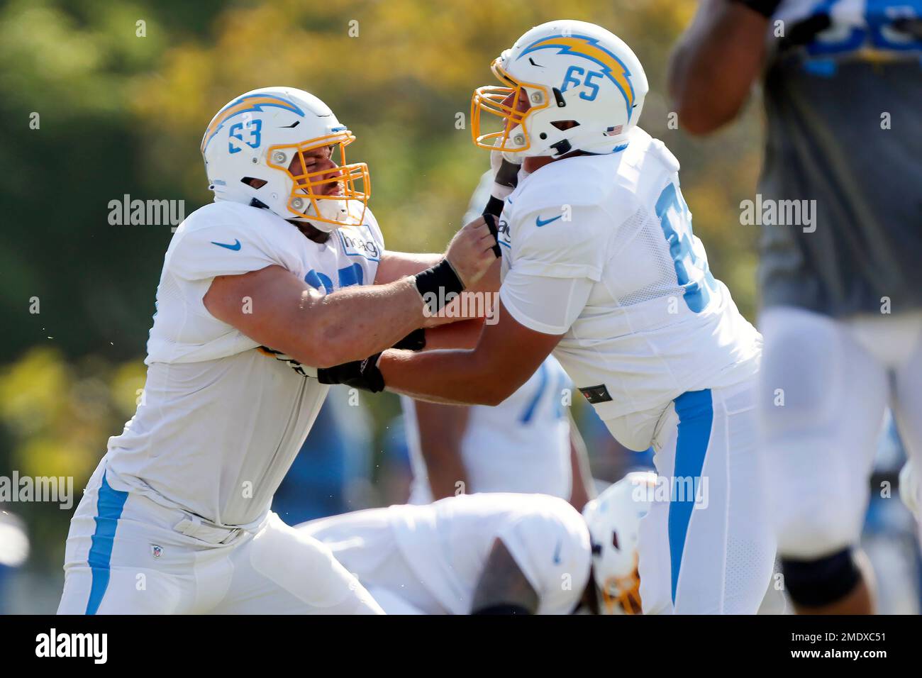 Los Angeles Chargers center Corey Linsley, left, works on a drill with ...