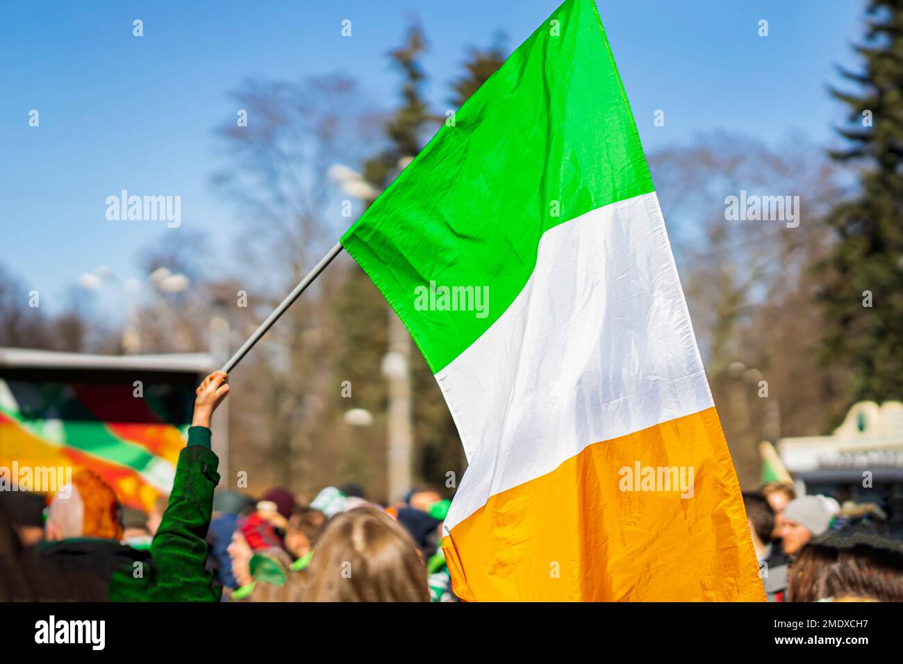 National Flag of Ireland close-up above people crowd people ...