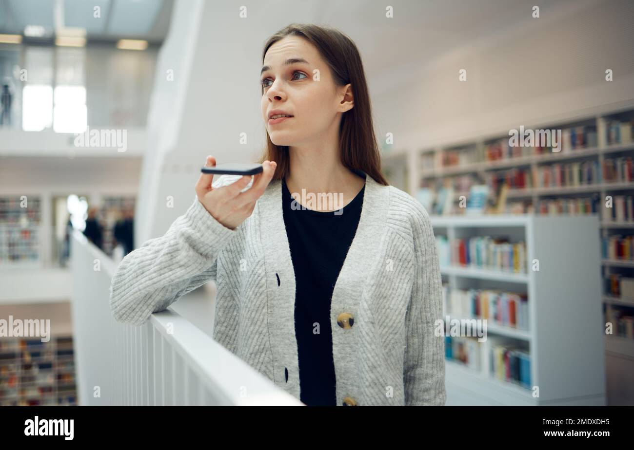 Phone, communication and student woman in a library education and ...