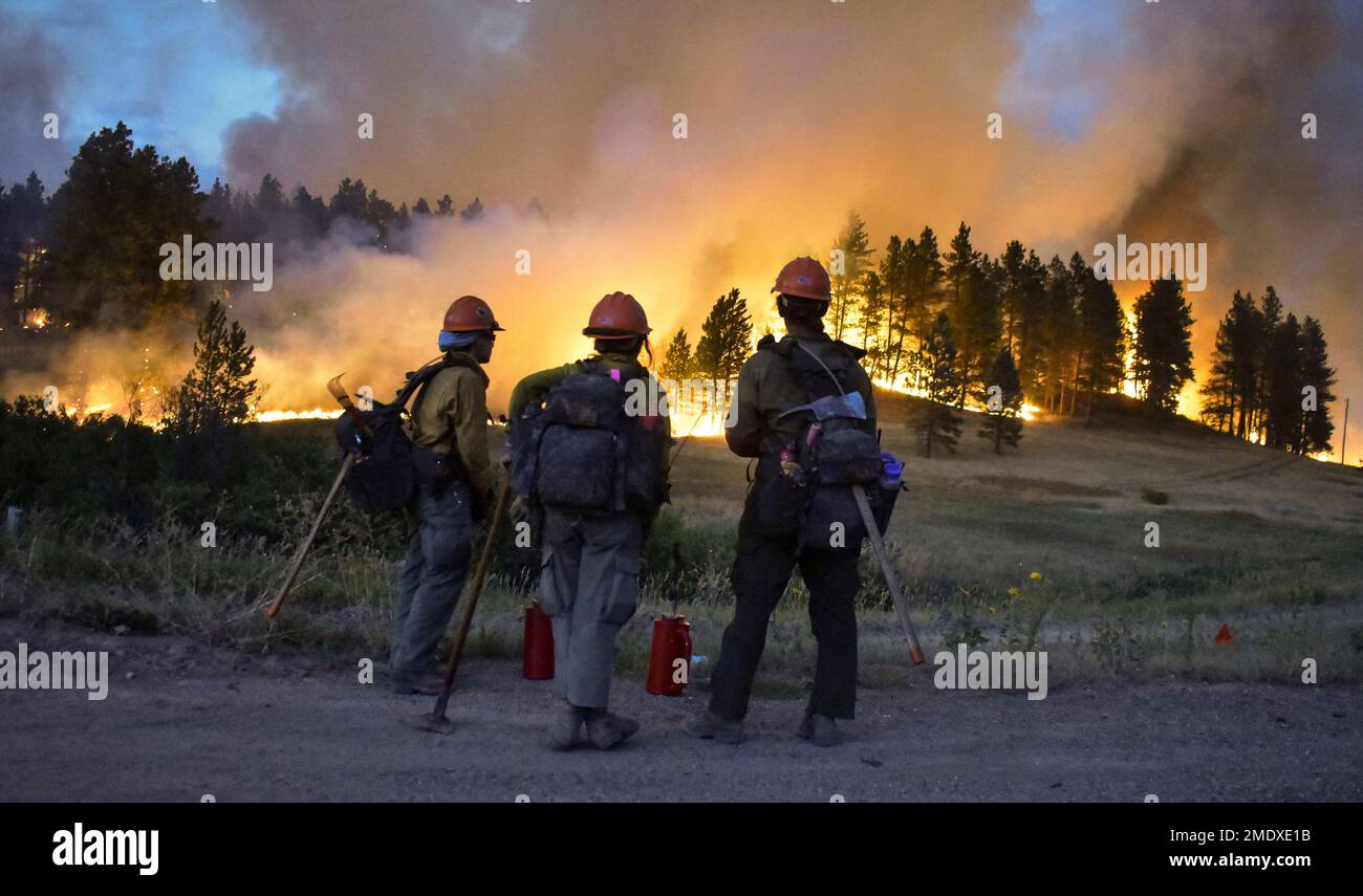 Firefighters watch a hillside burn on the Northern Cheyenne Indian ...