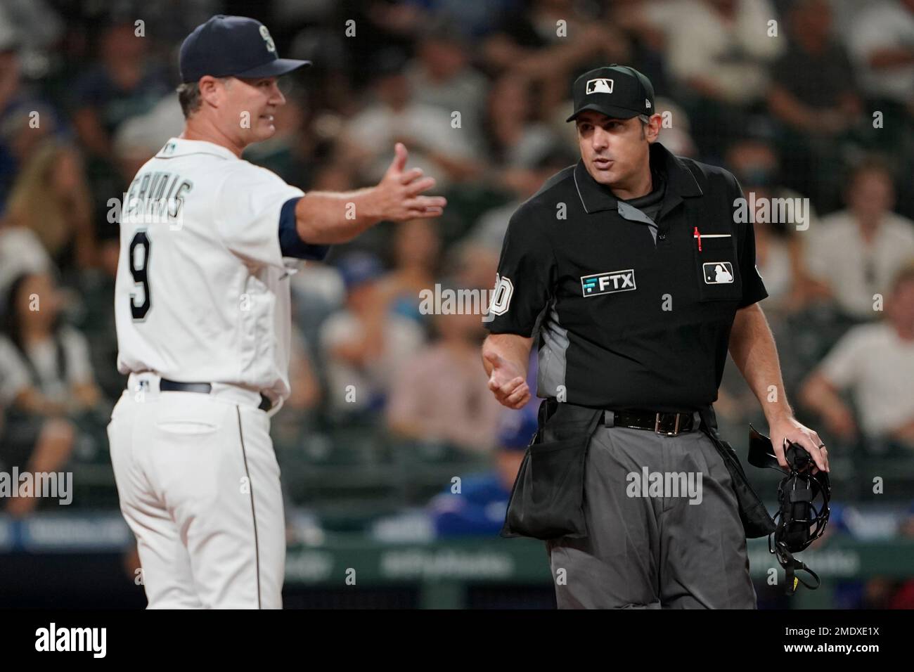 Seattle Mariners manager Scott Servais, left, argues with home plate ...