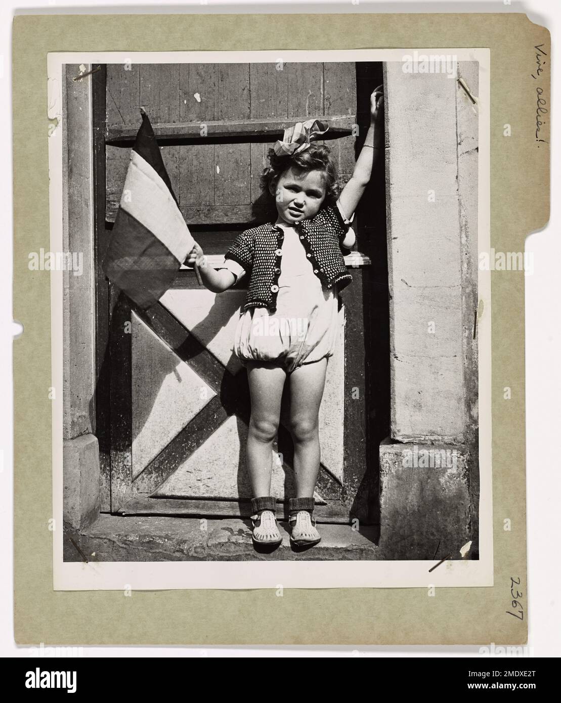 A French girl waves a Tri-color flag to greet a Coast Guard combat ...