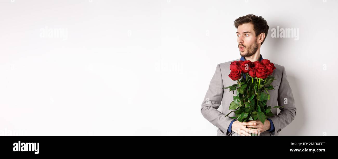 Nervous boyfriend waiting for his date on valentines day, looking left ...