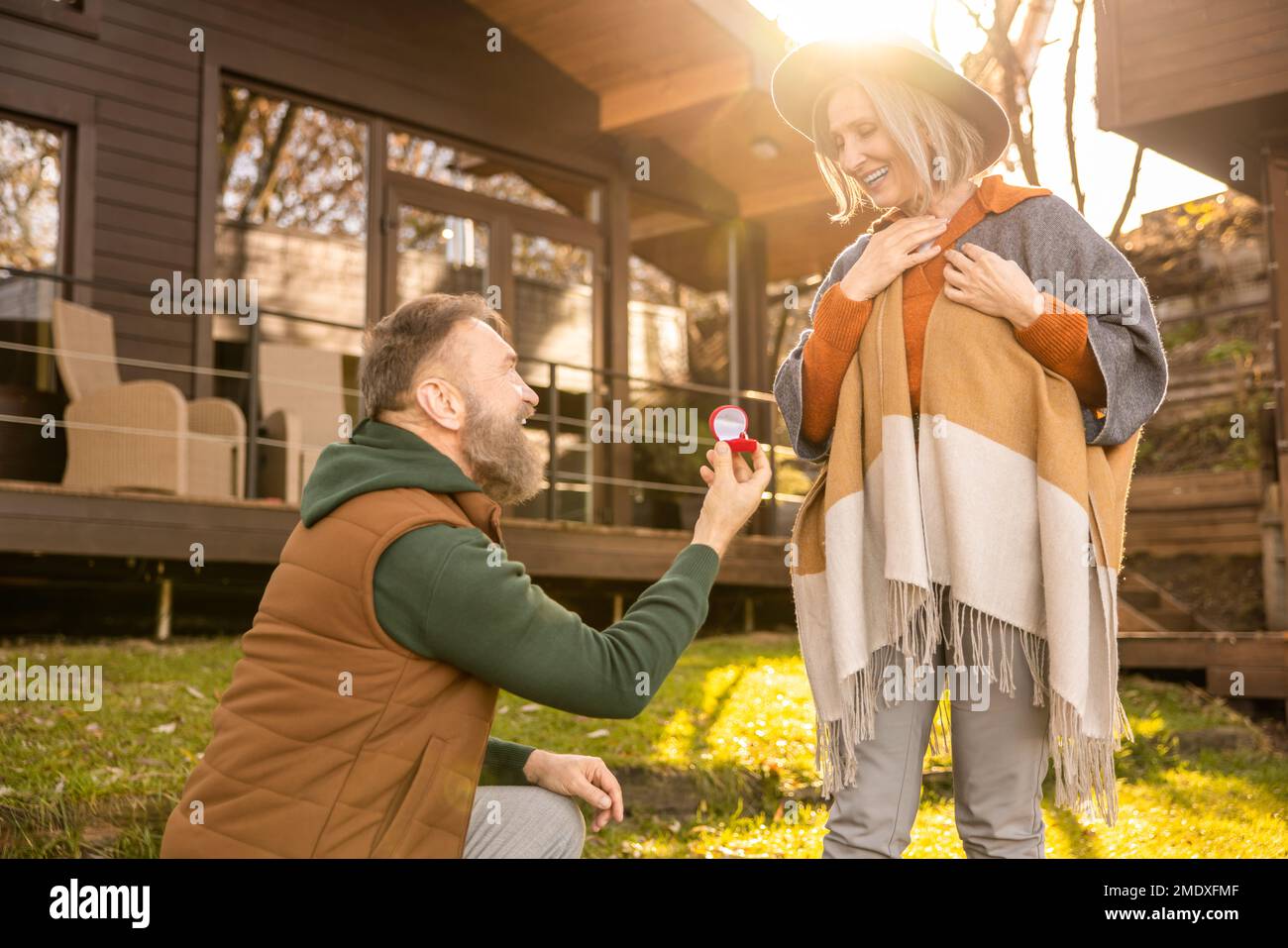 Man making a proposal to his beloved and giving an engagement ring ...