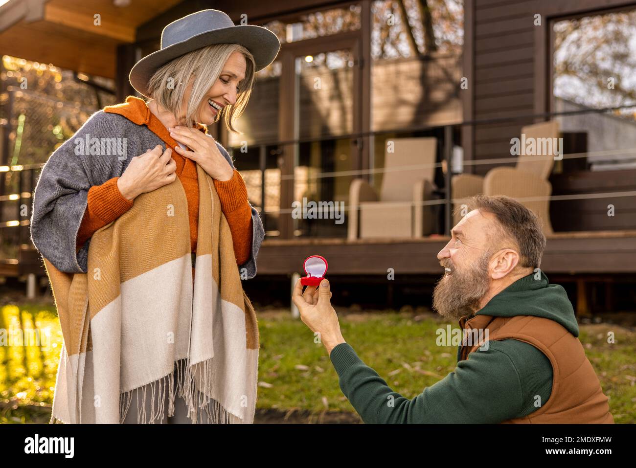 Man making a proposal to his beloved and giving an engagement ring ...