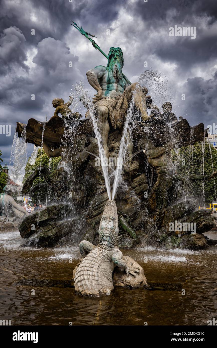 The Neptune Fountain against stormy sky in city of Berlin in Germany ...