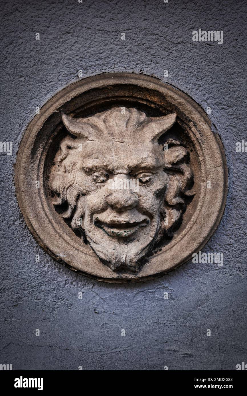 Face of the Devil with evil smile stone relief, small creepy ...