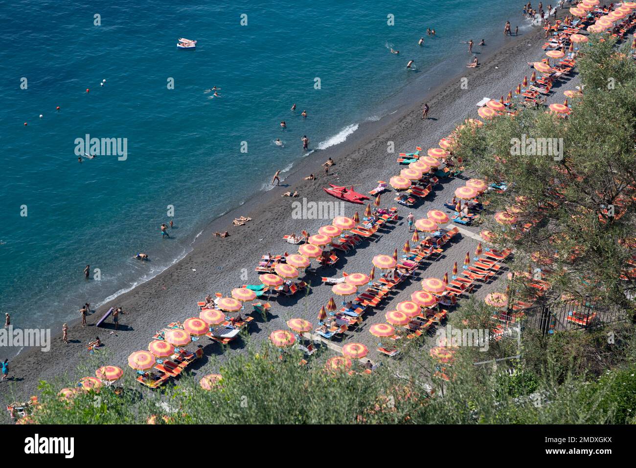 View of sunbathers and swimmers on beach in Positano, Amalfi Coast ...