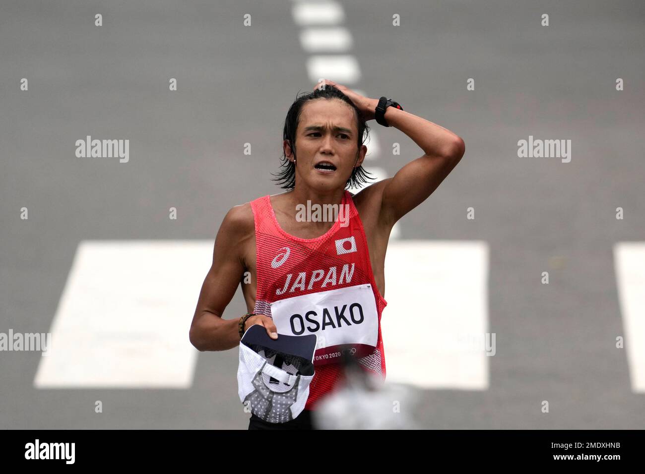 Suguru Osako of Japan, reacts after crossing the finish line during the ...