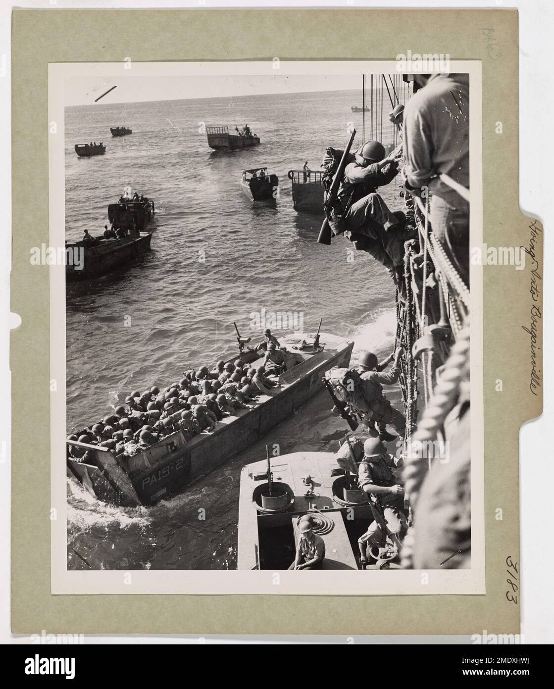U.S. troops embark from a Coast Guard-manned combat transport, entering ...
