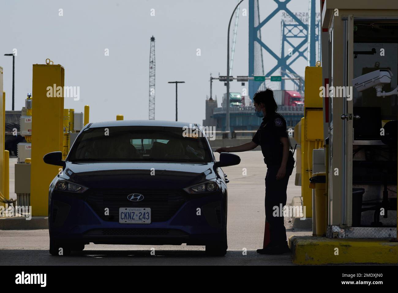 A U.S. Customs and Border Protection agent questions a vehicle entering ...