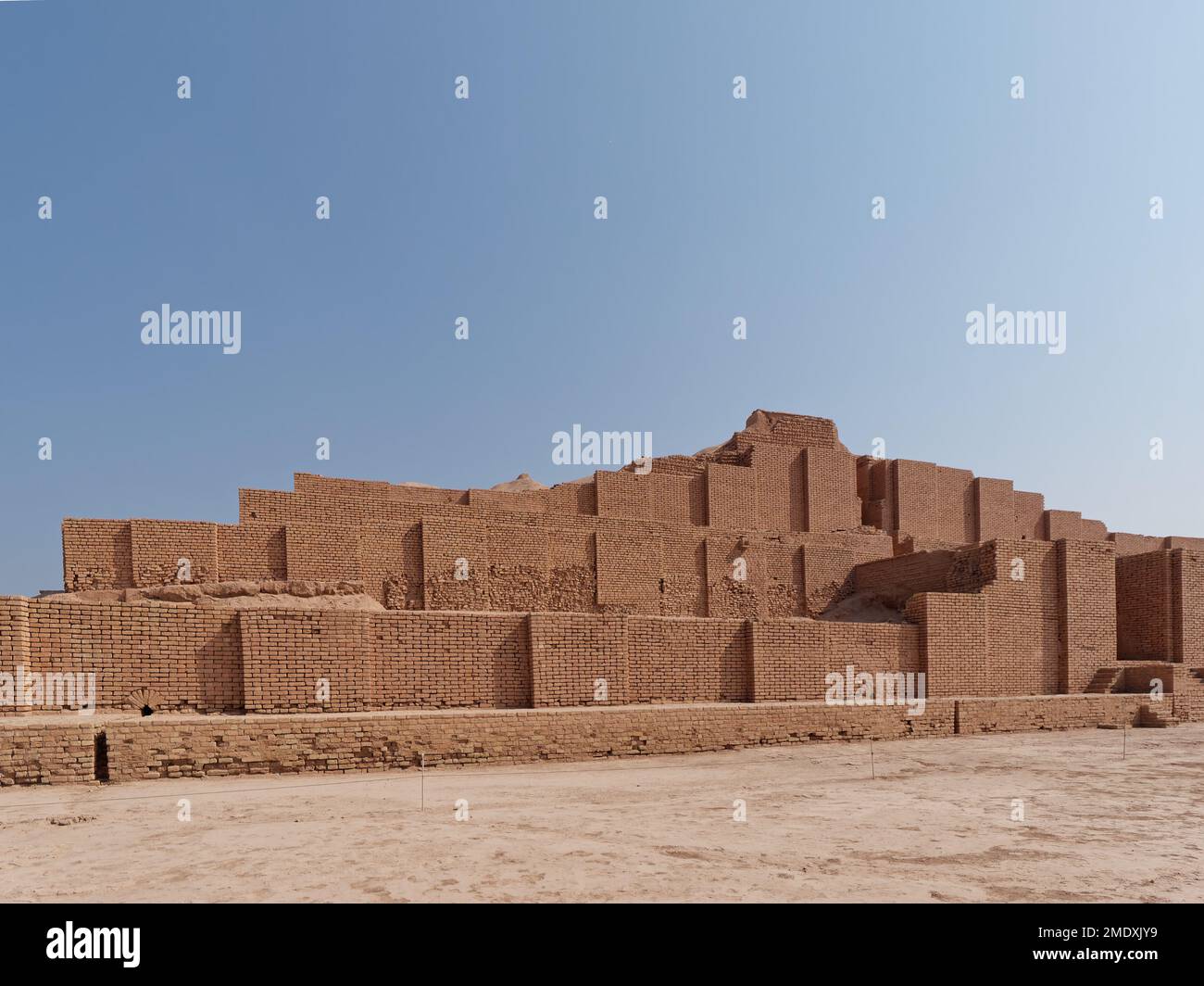 A beautiful shot of the historic Ziggurat of Chogha Zanbil under a blue ...