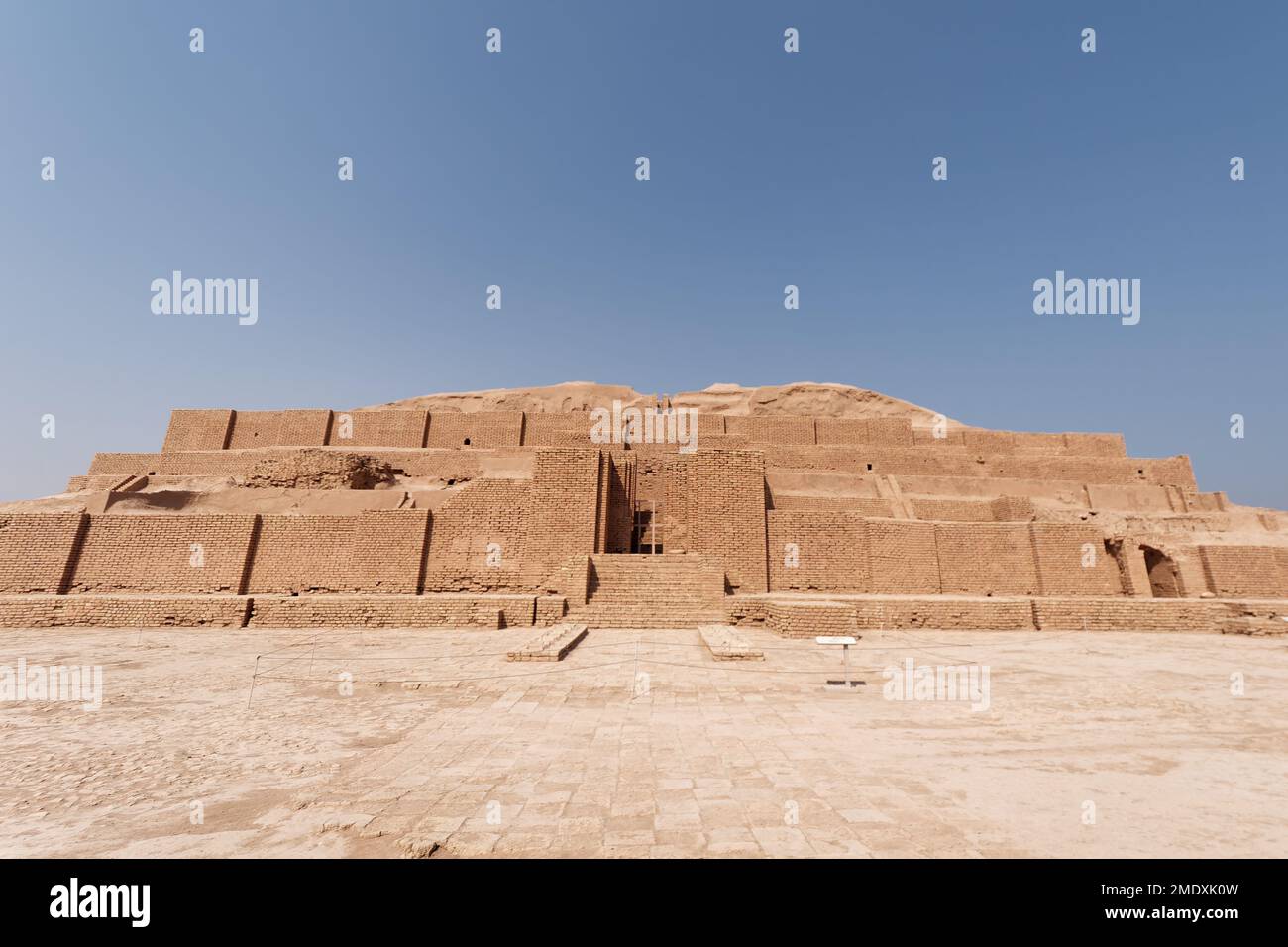 A beautiful shot of the historic Ziggurat of Chogha Zanbil under a blue ...