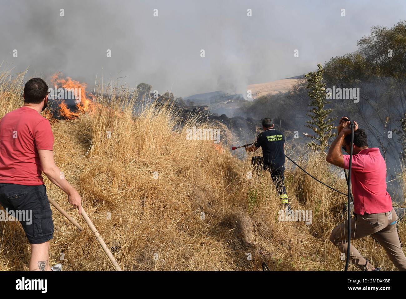 Volunteers try to control fire in the Municipality of Blufi, in the ...