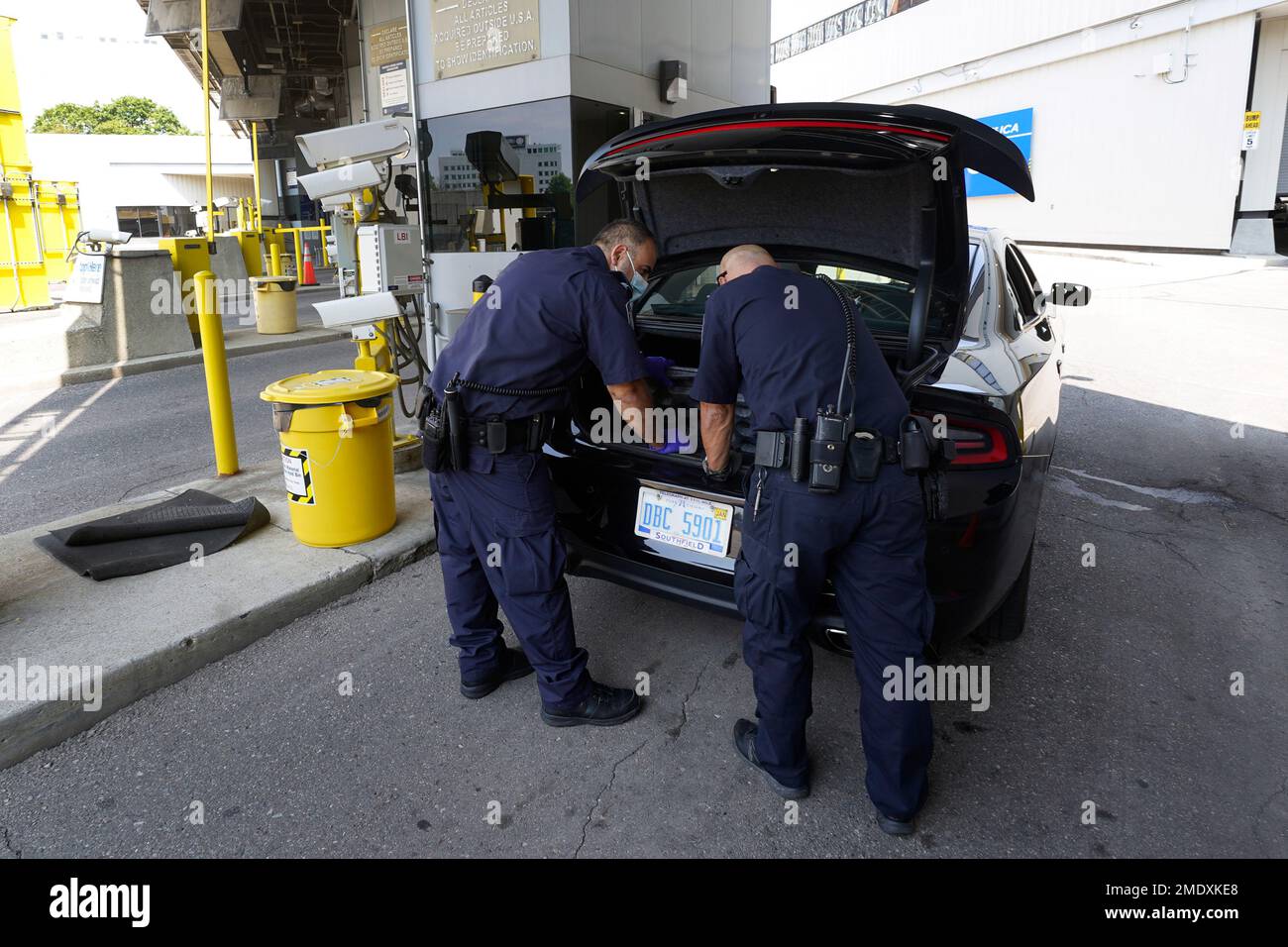 U.S. Customs and Border Protection agents check a vehicle entering the ...