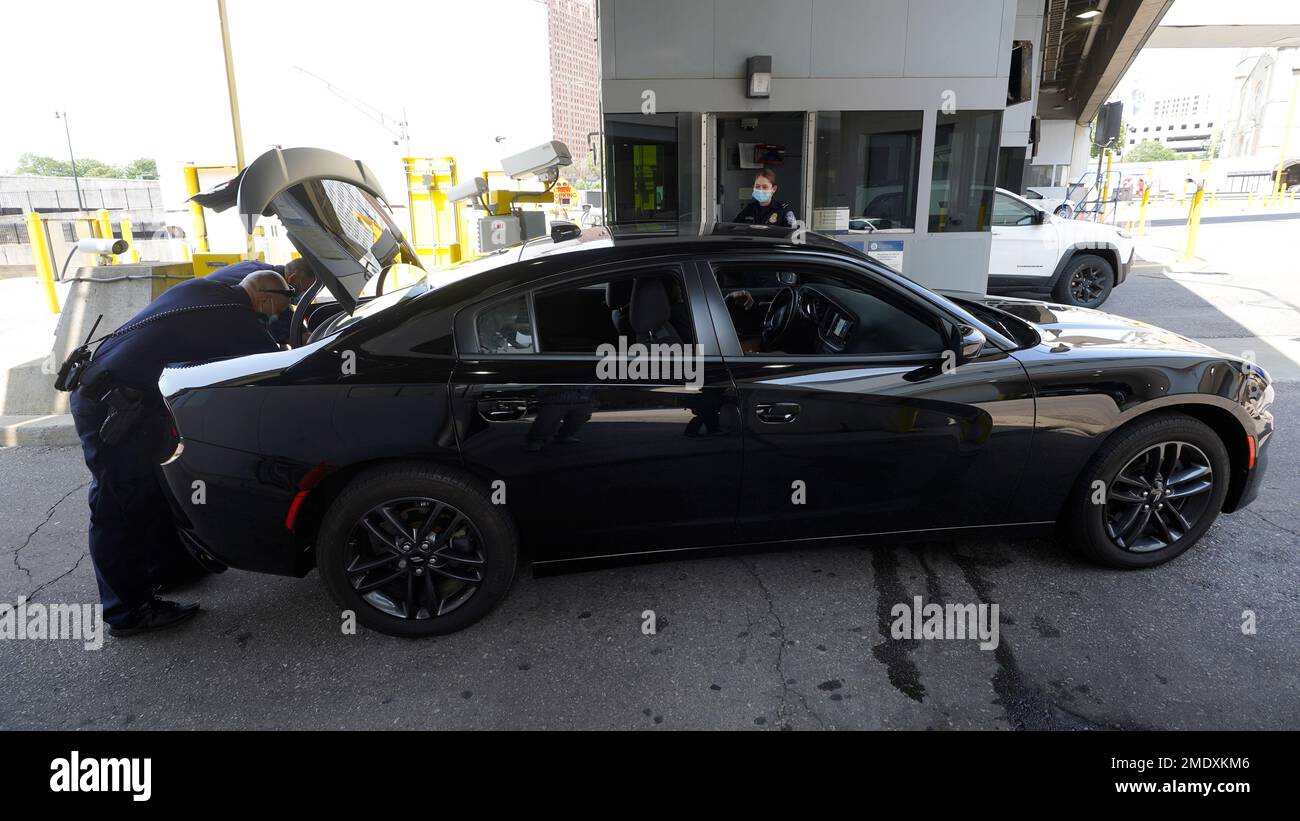 U.S. Customs and Border Protection agents check a vehicle entering the ...