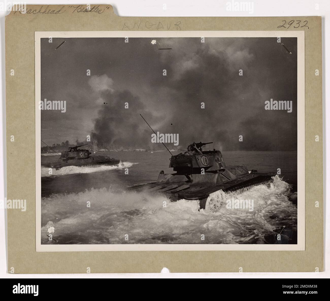 Amphibious tanks race toward the fiery beach of Angaur Island in the ...