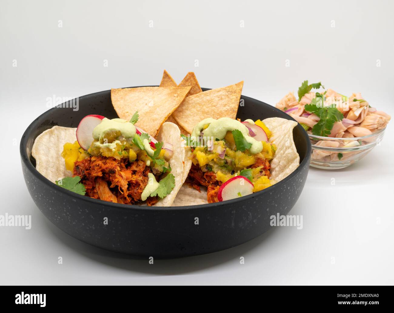 Healthy vegan jackfruit tacos in a black bowl on white background Stock ...
