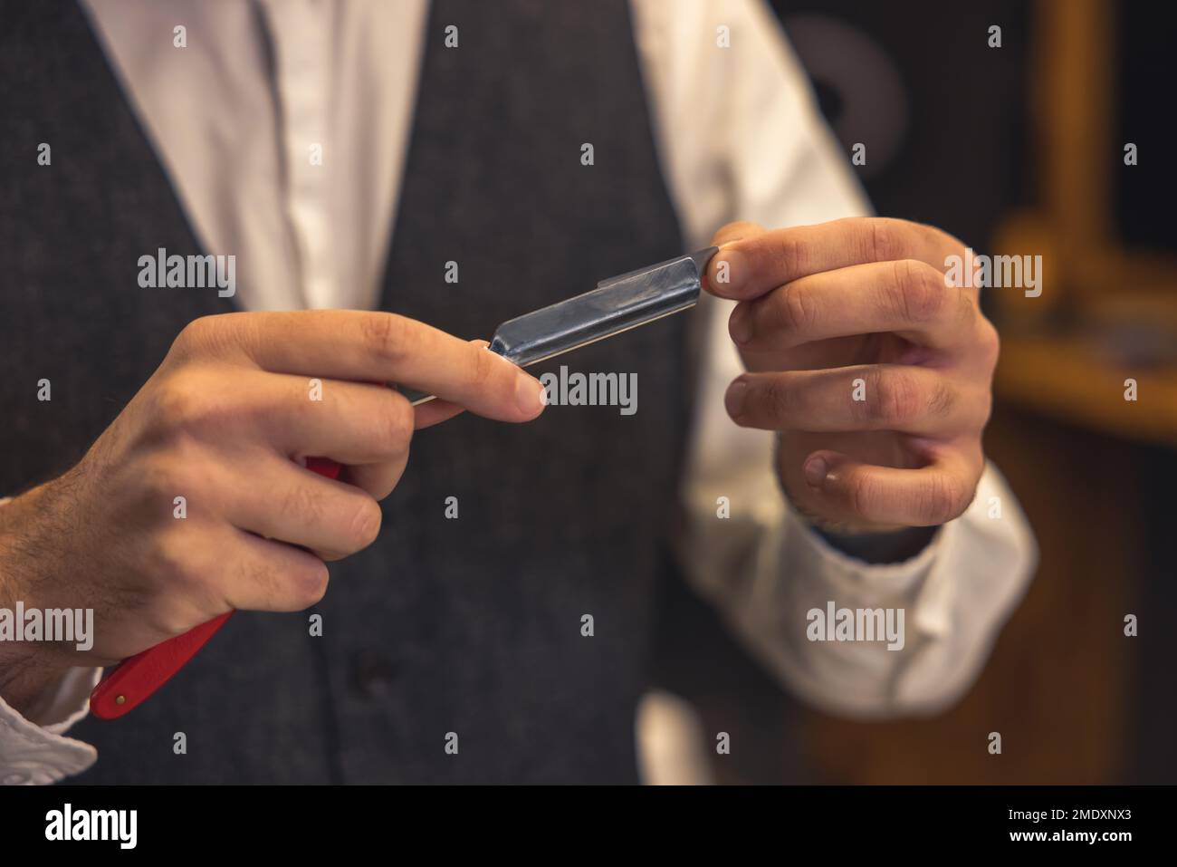 Barber checking the razor sharpness Stock Photo - Alamy