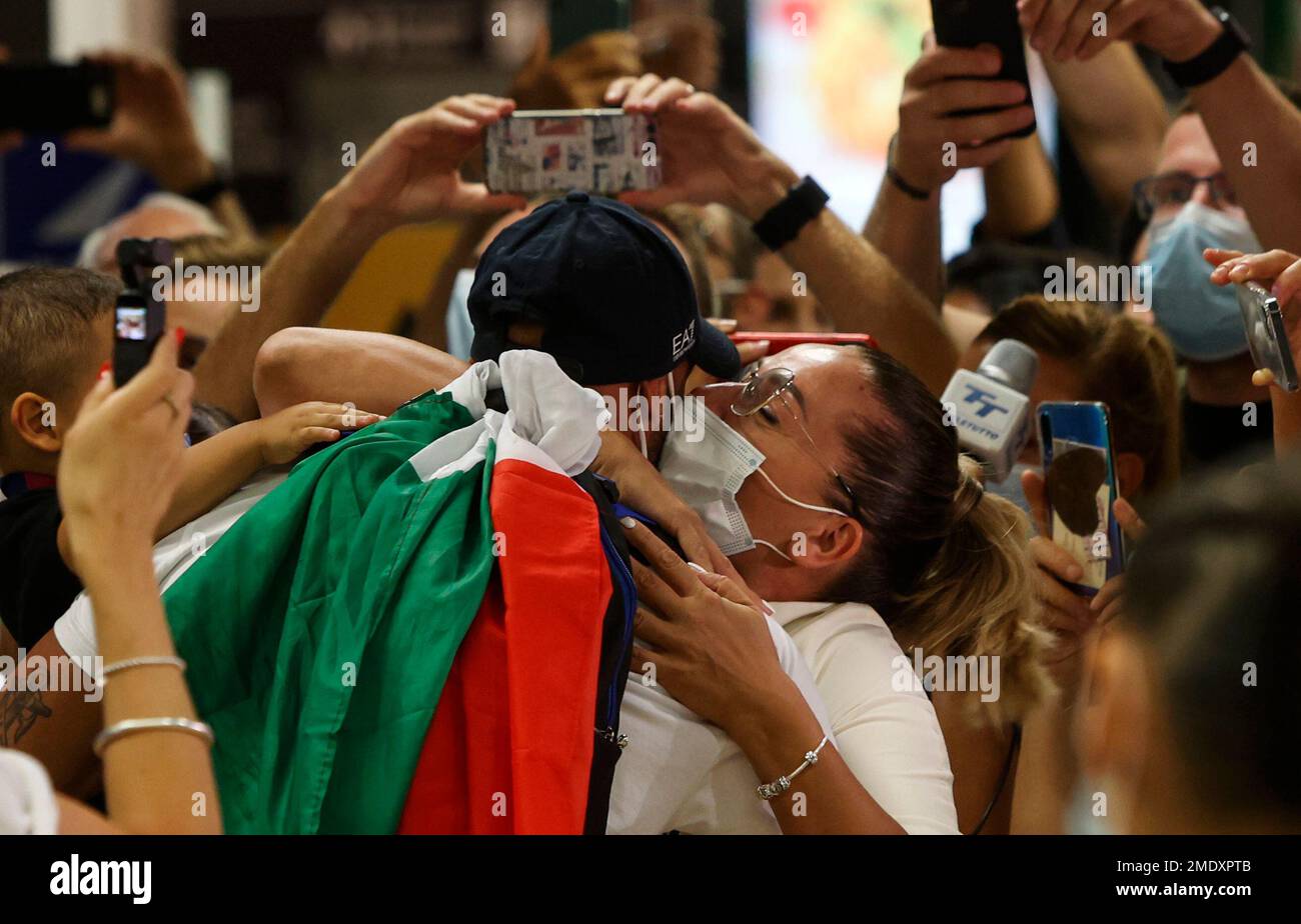 Italian sprinter Marcell Jacobs, left, is welcomed by his mother ...