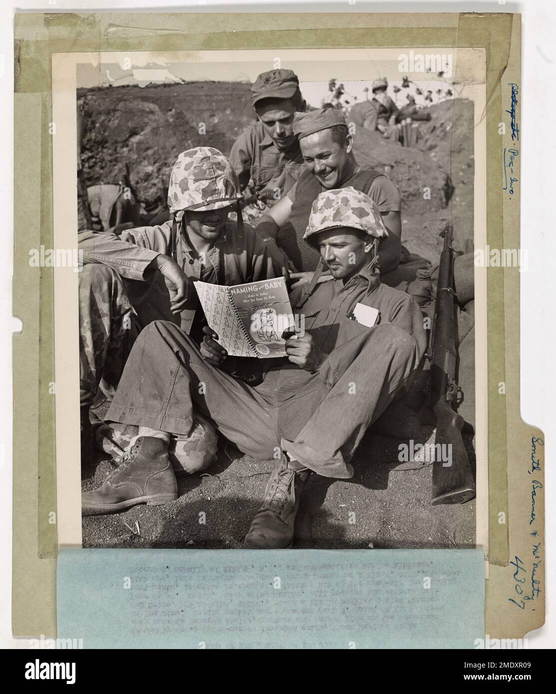 Marines on the beachhead at Iwo Jima take a break between mortar fire ...