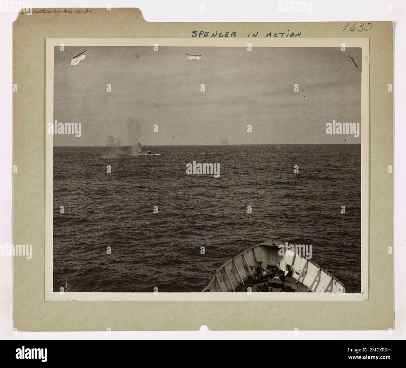 The Coast Guard cutter Spencer is depicted firing on a German submarine ...