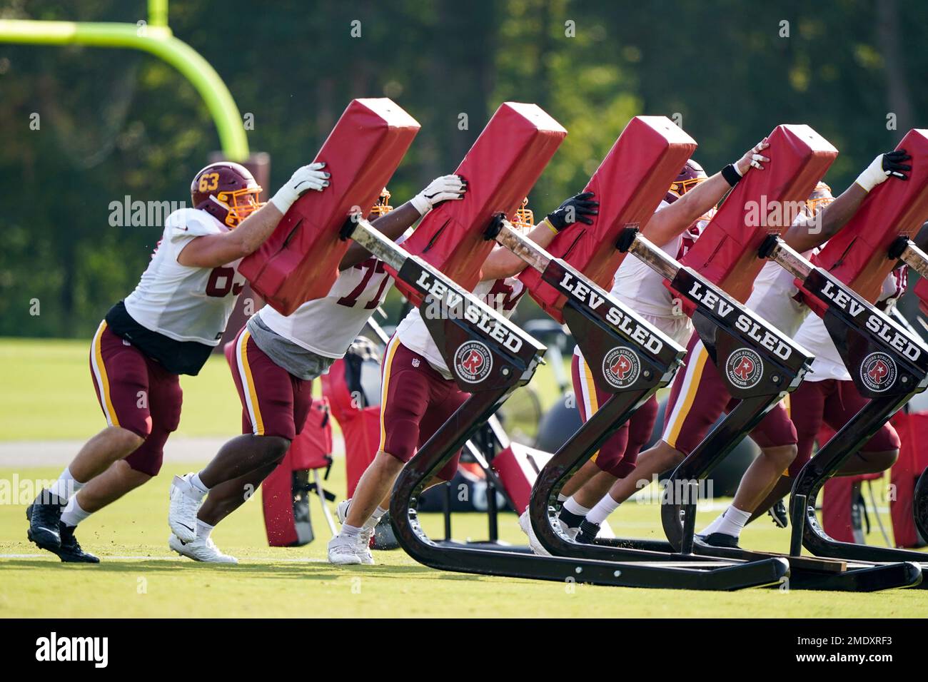The offensive line works against a sled during practice at the team's ...